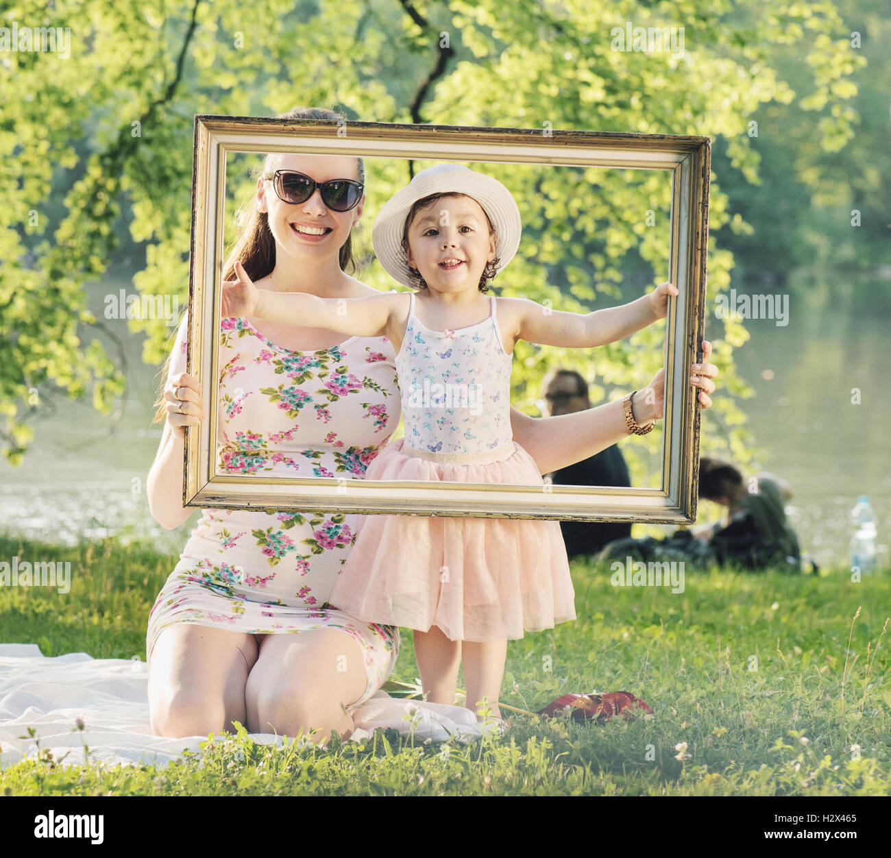 Pretty mother posing with her beloved daughter Stock Photo - Alamy