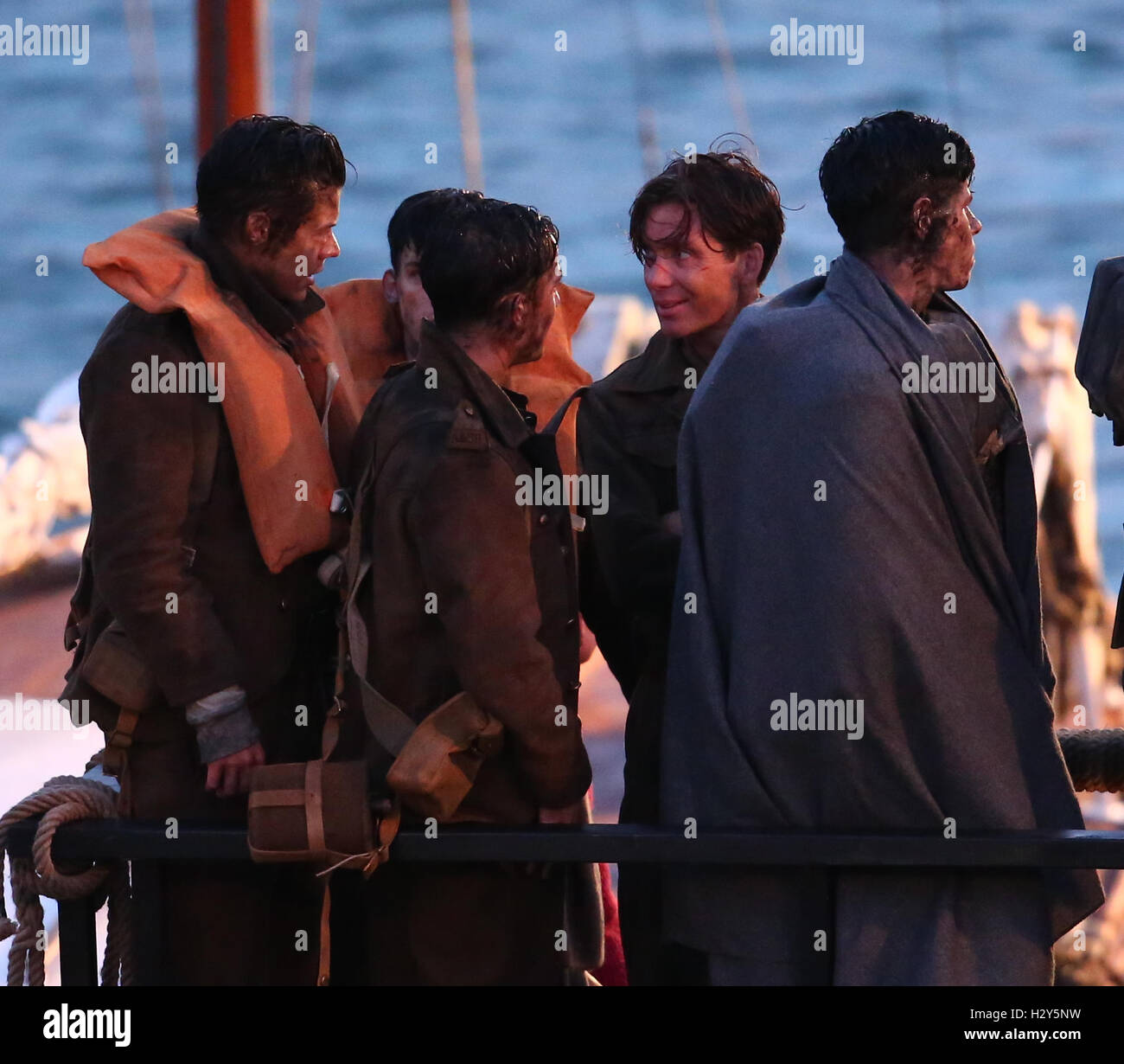 Harry Styles comes off a boat and walks along the dock. Featuring ...