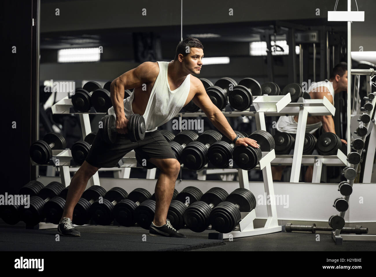 Hard working athletic man training with a dumbbell Stock Photo - Alamy