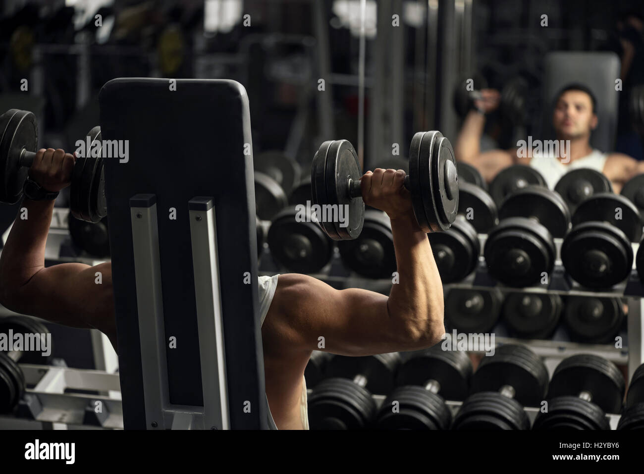 Strong hard working man lifting weight Stock Photo - Alamy