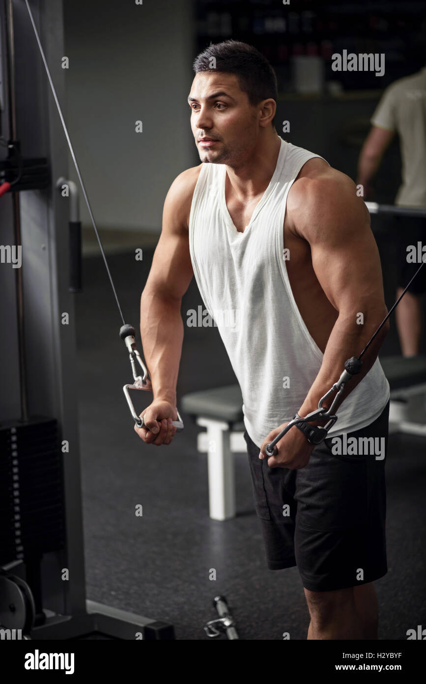 Good looking determined man developing his physical strength Stock ...