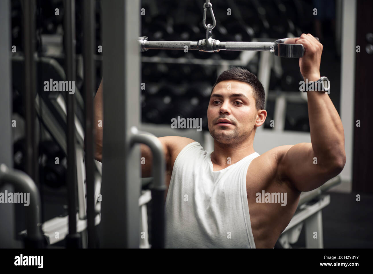 Persistent serious man training in a gym Stock Photo - Alamy