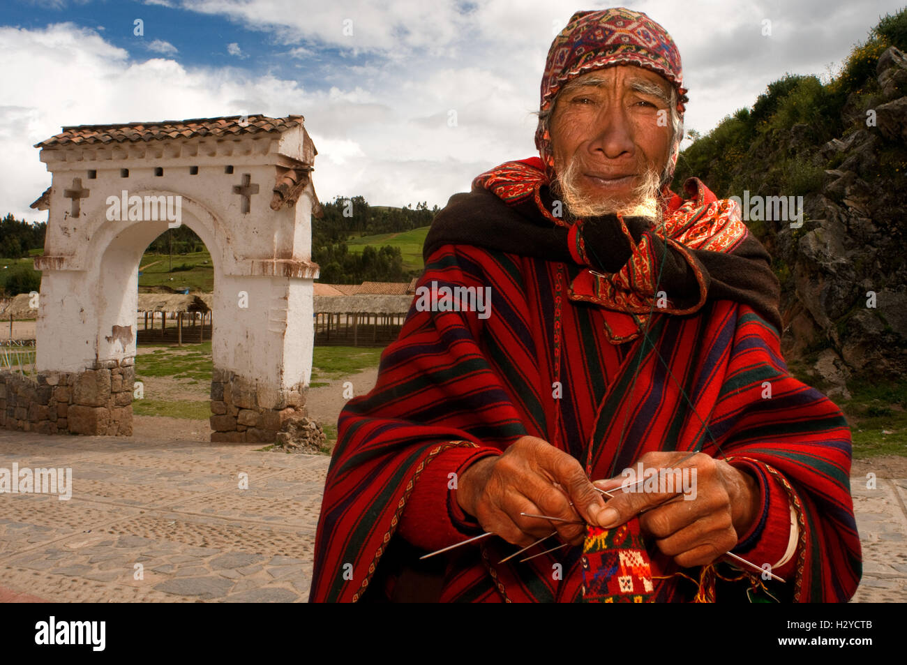 An artisan weaves a hat on the streets of Chinchero in the Sacred ...