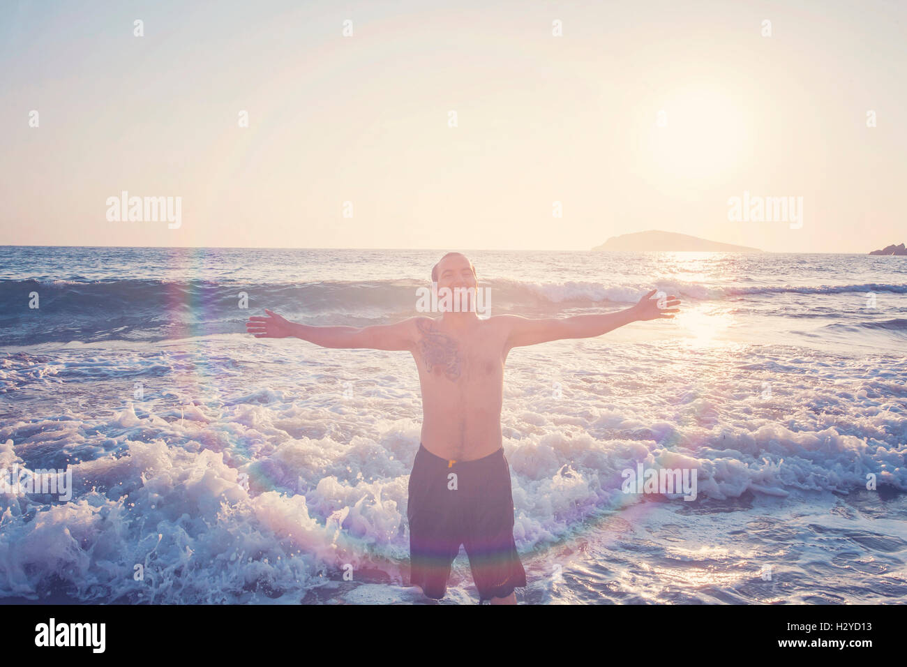 Young man enjoying sunny day by the ocean Stock Photo - Alamy