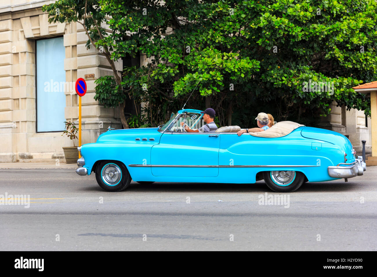 Blue convertible American classic car driving in the old town, Havana ...
