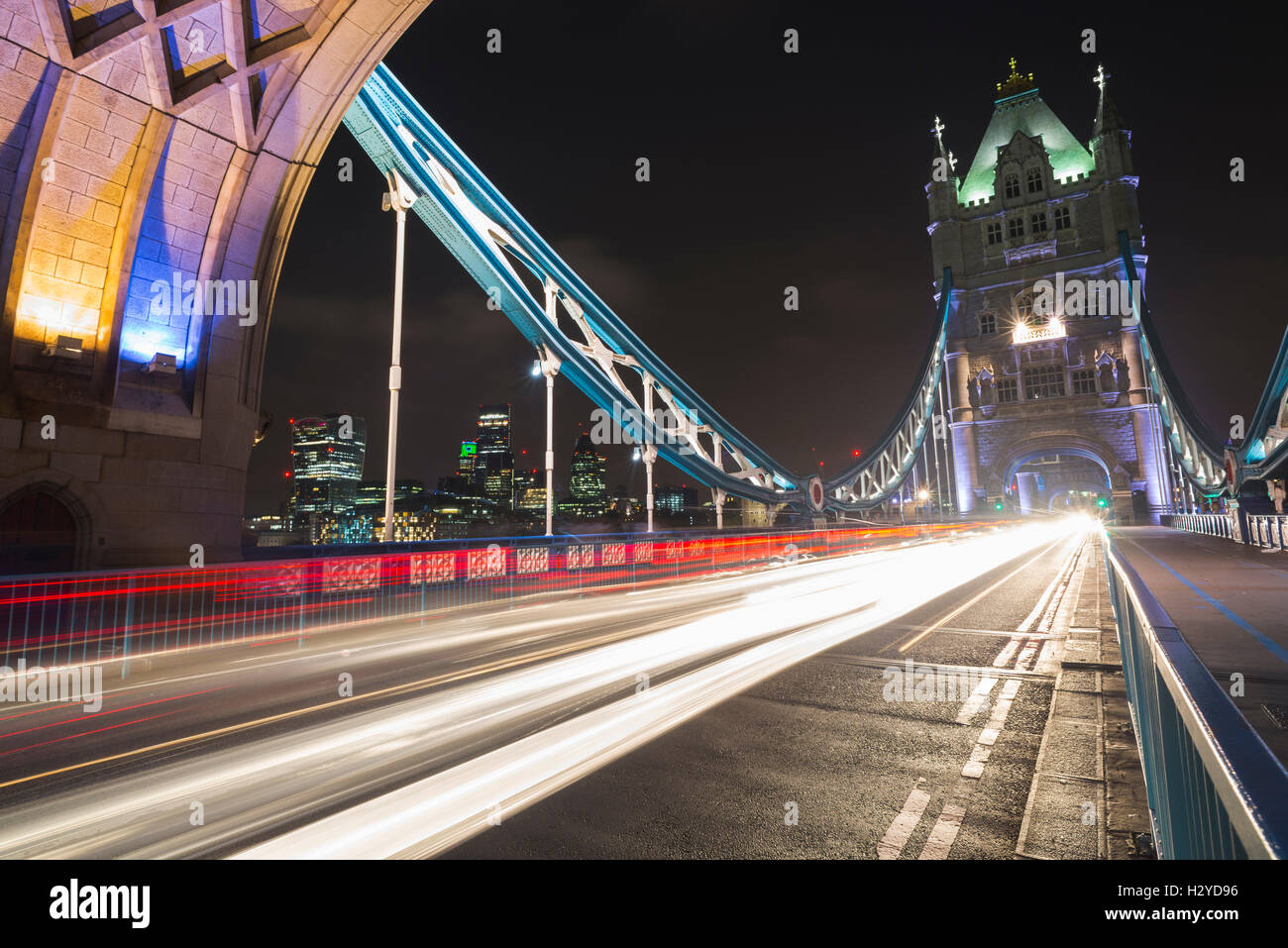Skyline of City of London and gleam of traffic on the Tower Bridge over ...