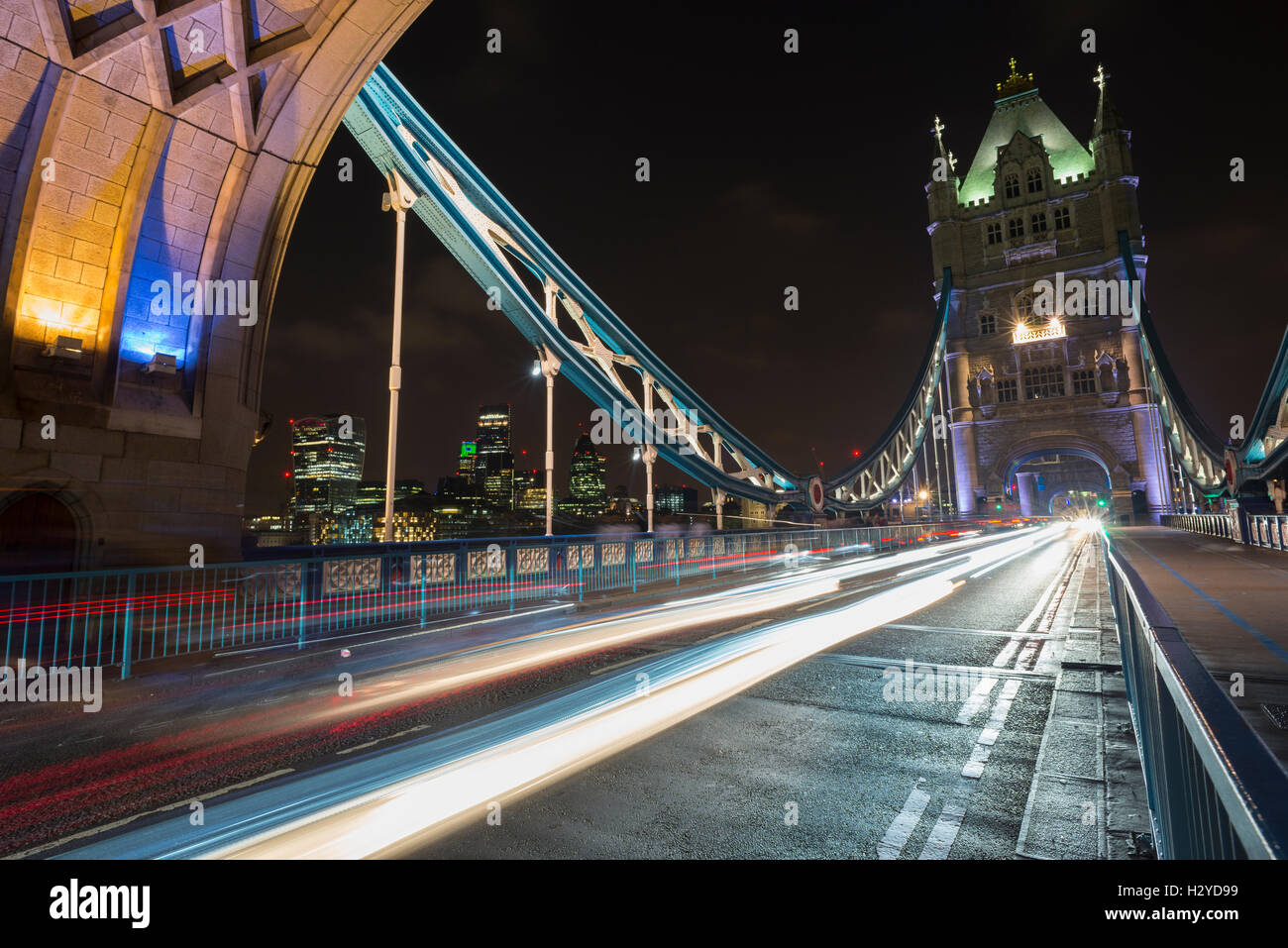 Skyline of the City of London behind the gleam of traffic on the Tower ...