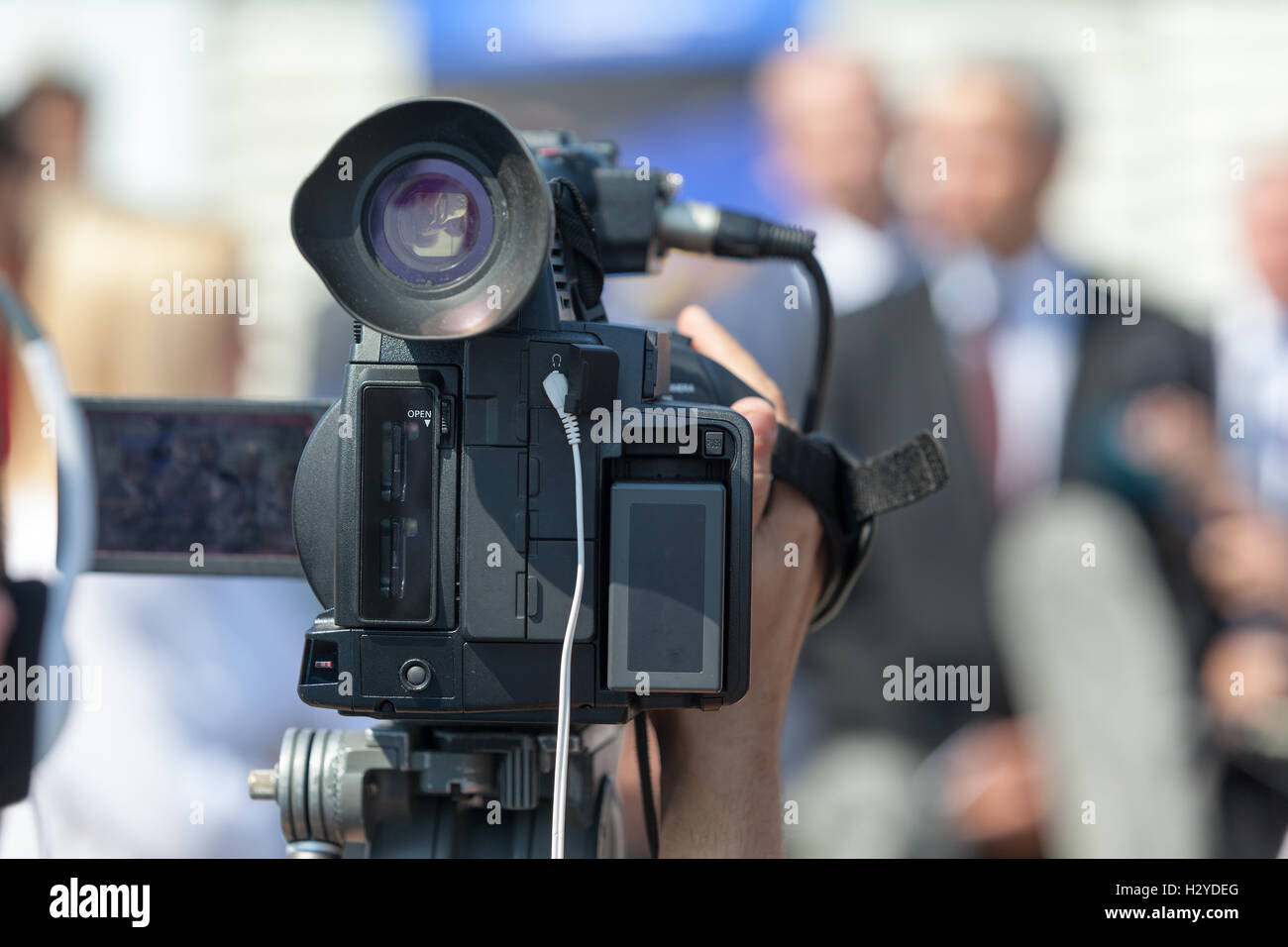Filming an event with a video camera. Press conference. Spokesperson ...