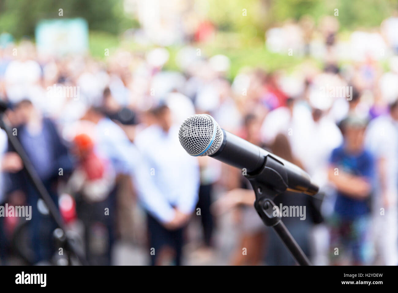 Microphone in focus against blurred audience. Protest. Public ...