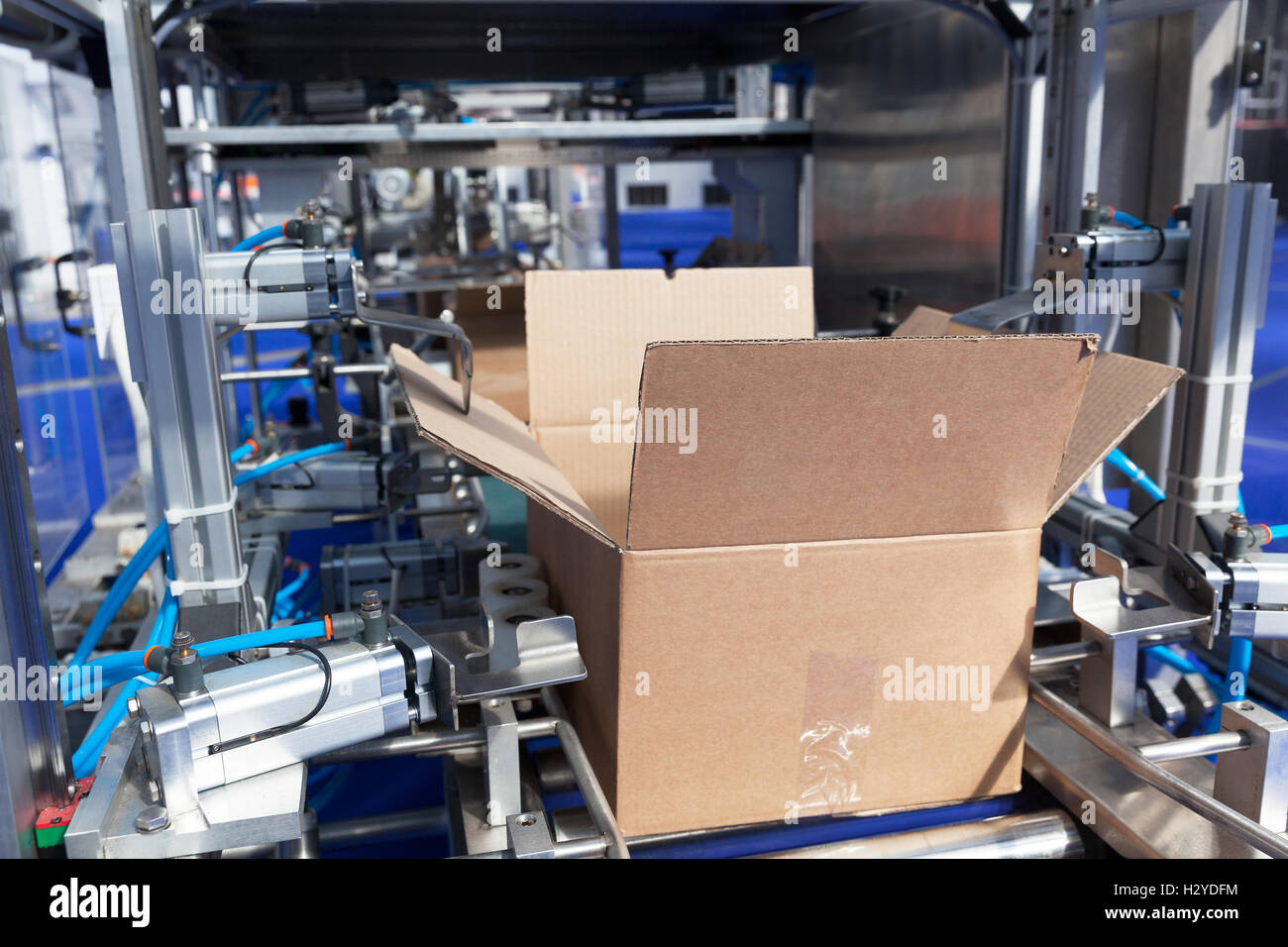 Automatic cardboard box erector machine Stock Photo - Alamy