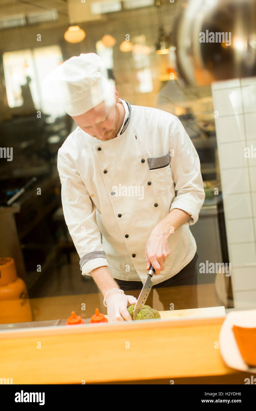Chef preparing food in the kitchen at the restaurant Stock Photo - Alamy