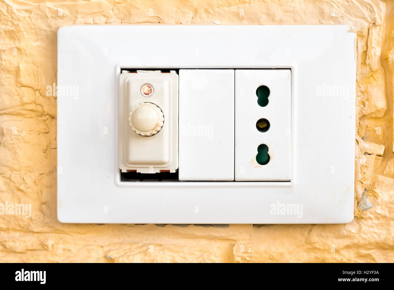 dimmer socket device orange brick wall background Stock Photo - Alamy