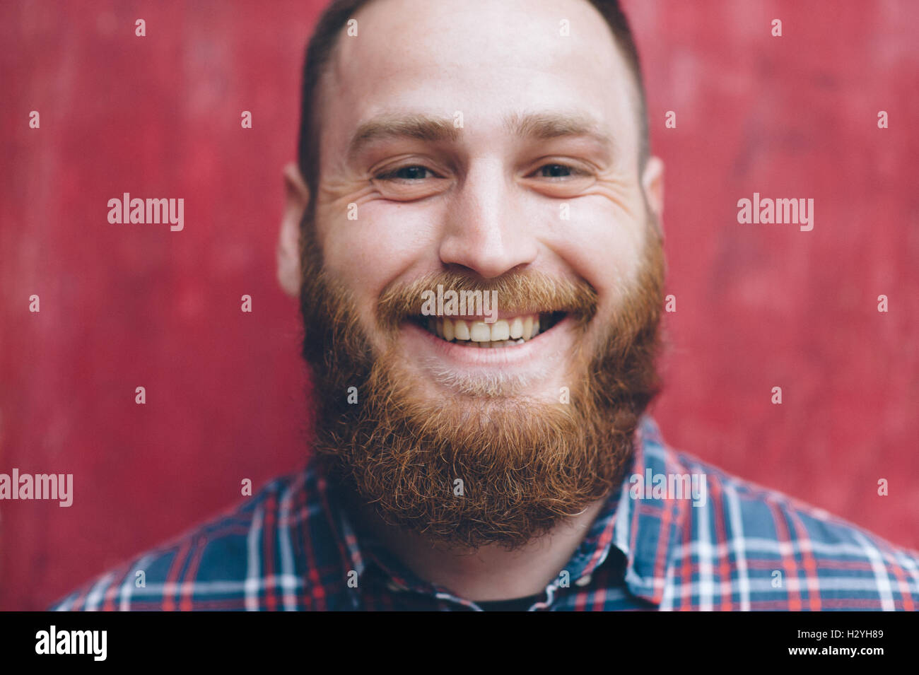 beautiful young man with beard smiling happily Stock Photo - Alamy