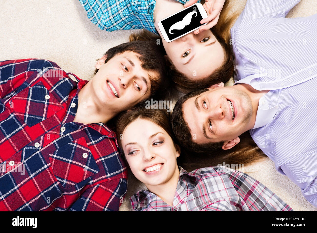 four young men lie together Stock Photo - Alamy
