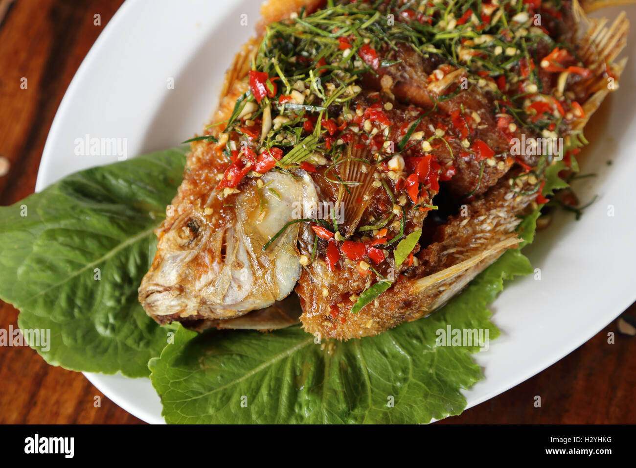 Fried ruby fish topped with sweet,sauer and hot sauce Stock Photo - Alamy