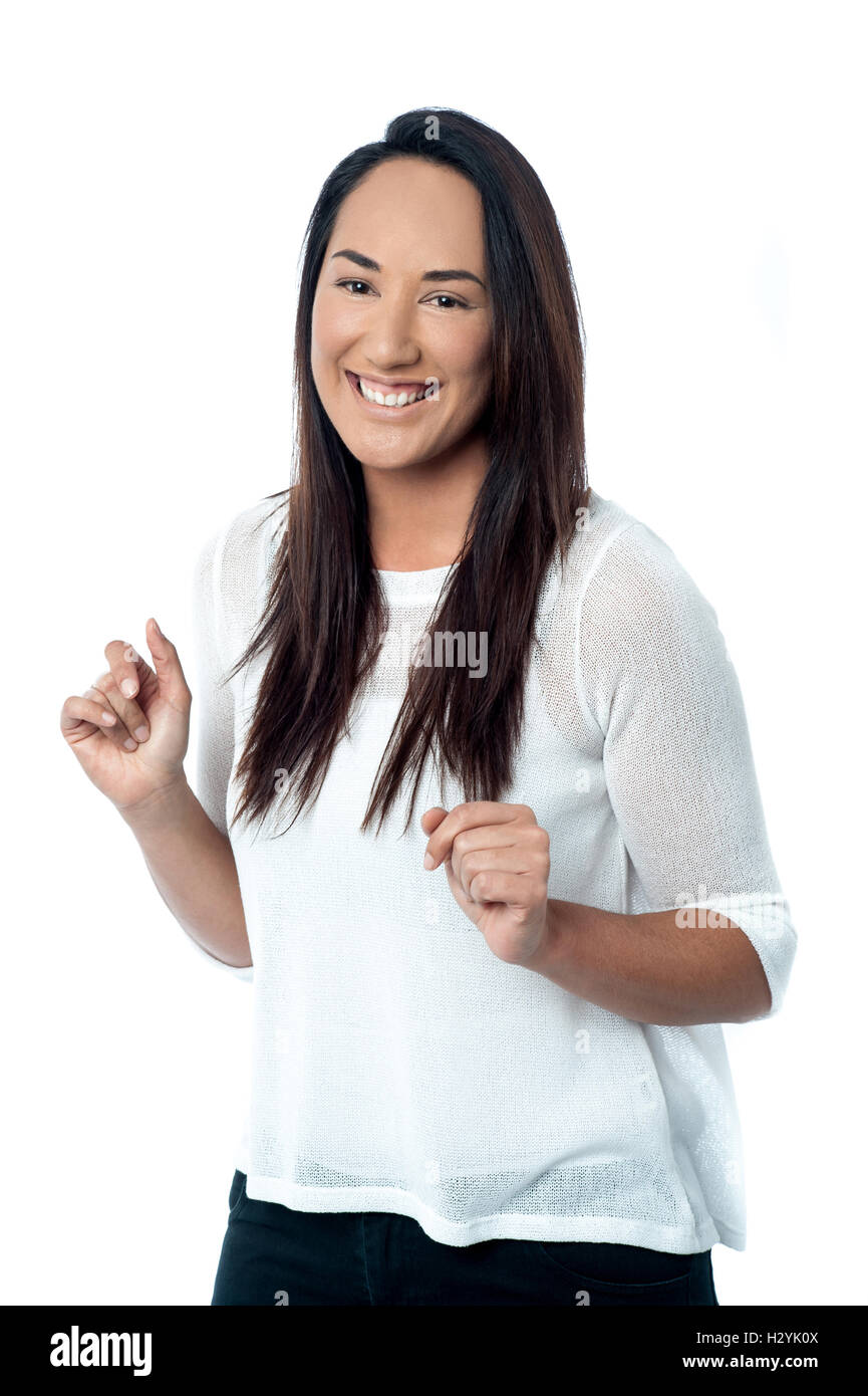 Cheerful woman dancing with arms up Stock Photo - Alamy