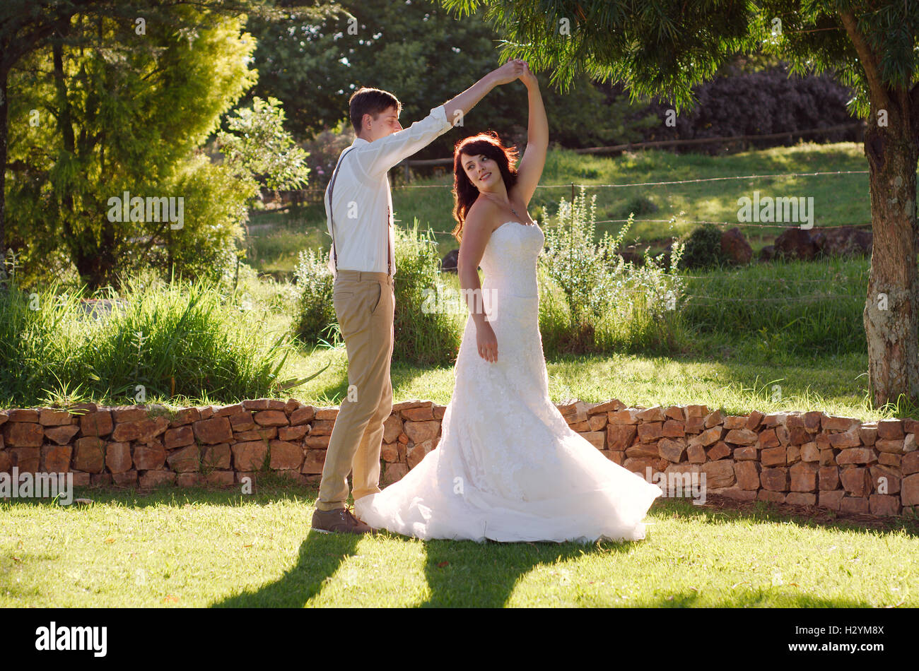 Bride and groom dancing in garden wedding Stock Photo - Alamy