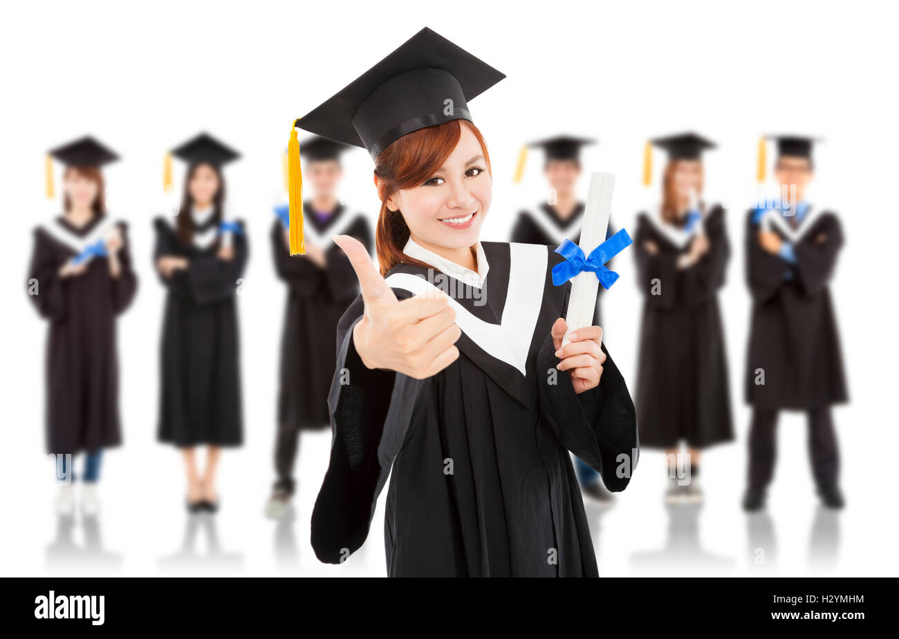 pretty graduation student thumb up with classmates Stock Photo - Alamy