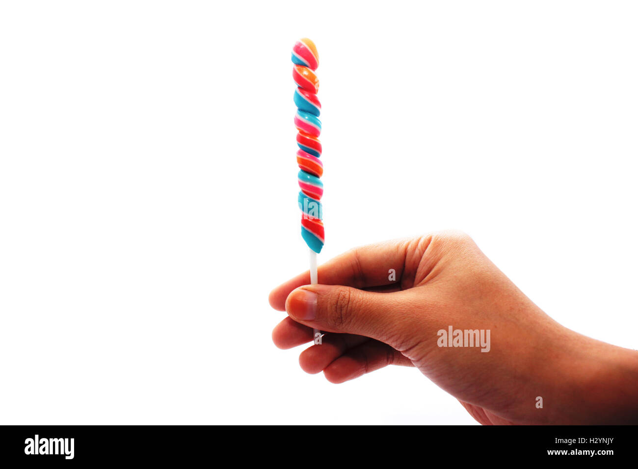 Hand holding a small candy lollipop Stock Photo - Alamy