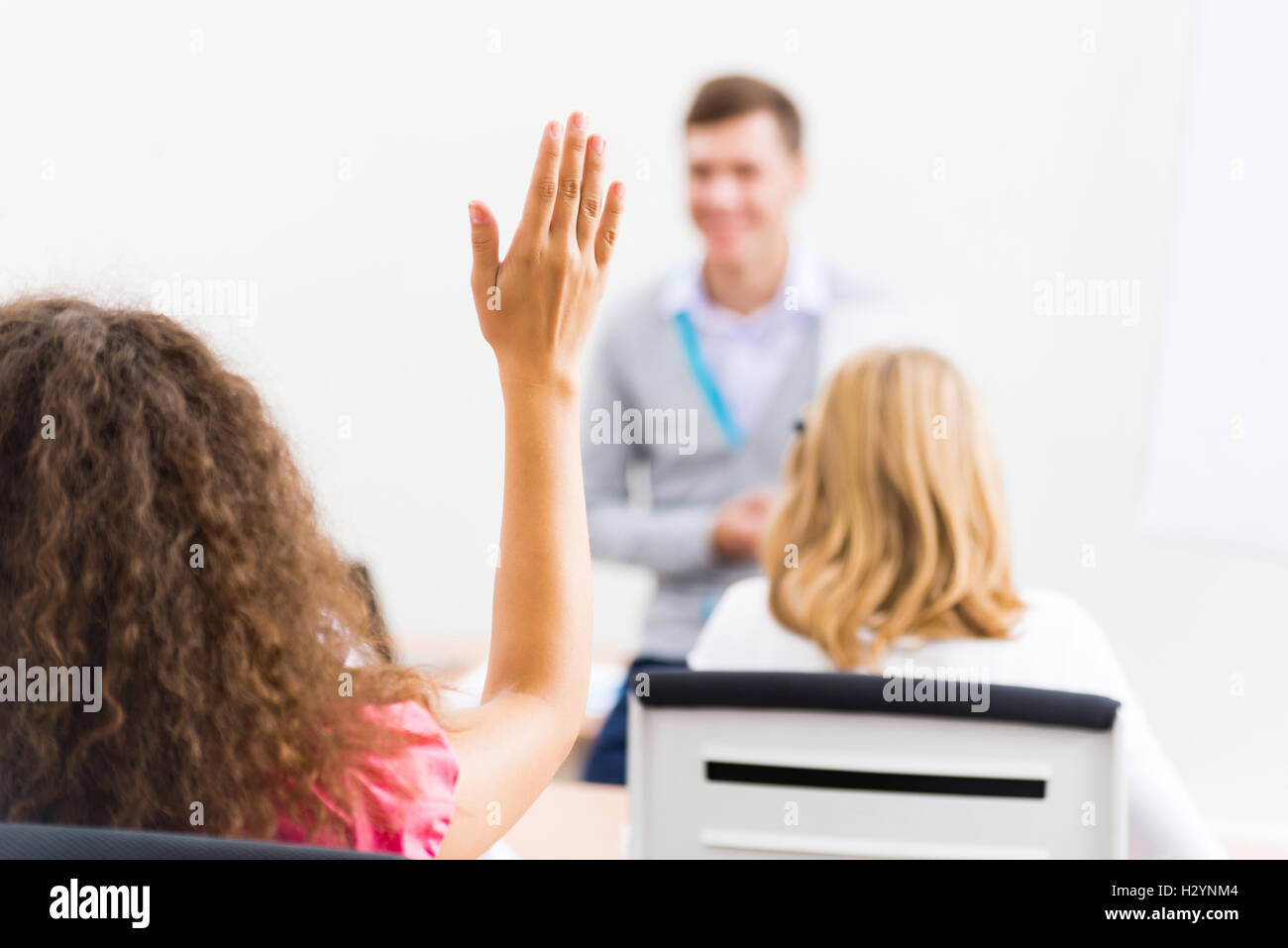female hand raised in class Stock Photo - Alamy