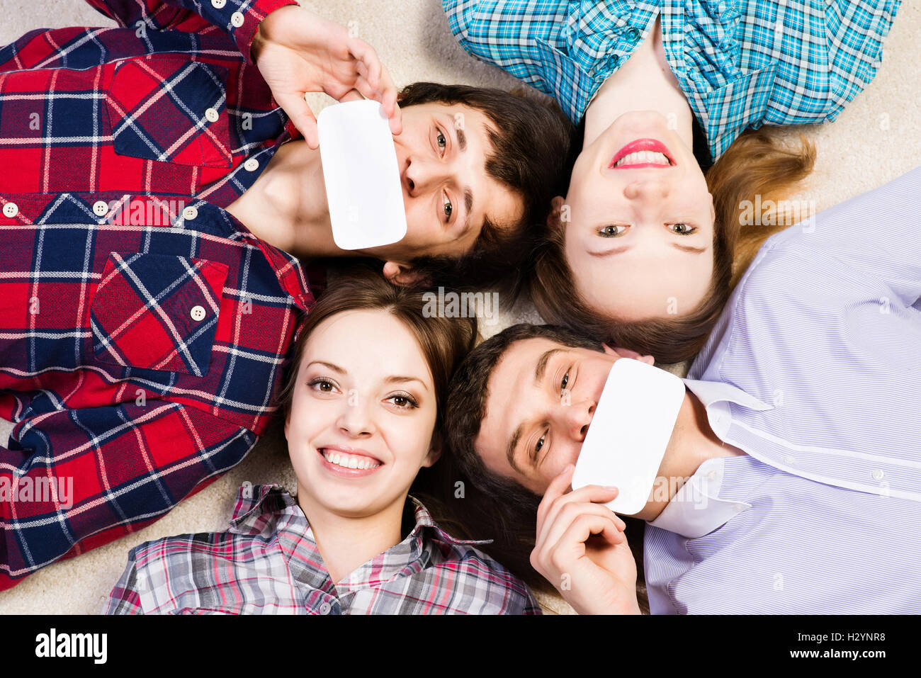 four young men lie together Stock Photo - Alamy