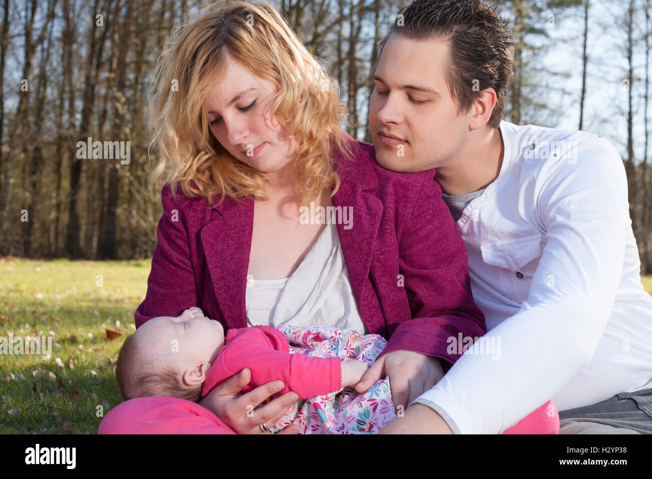 Young parents caring of their little baby girl Stock Photo - Alamy