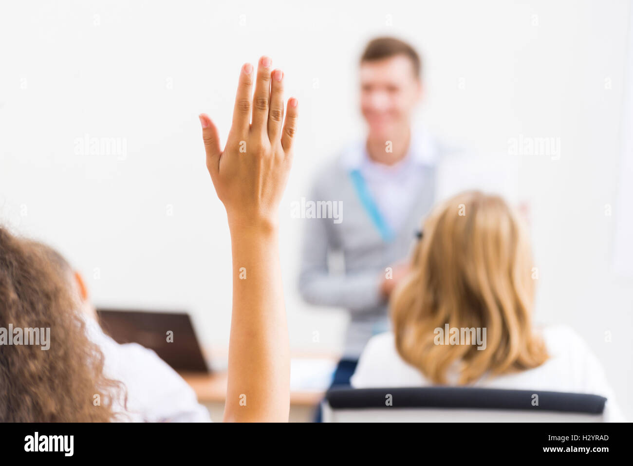 female hand raised in class Stock Photo - Alamy