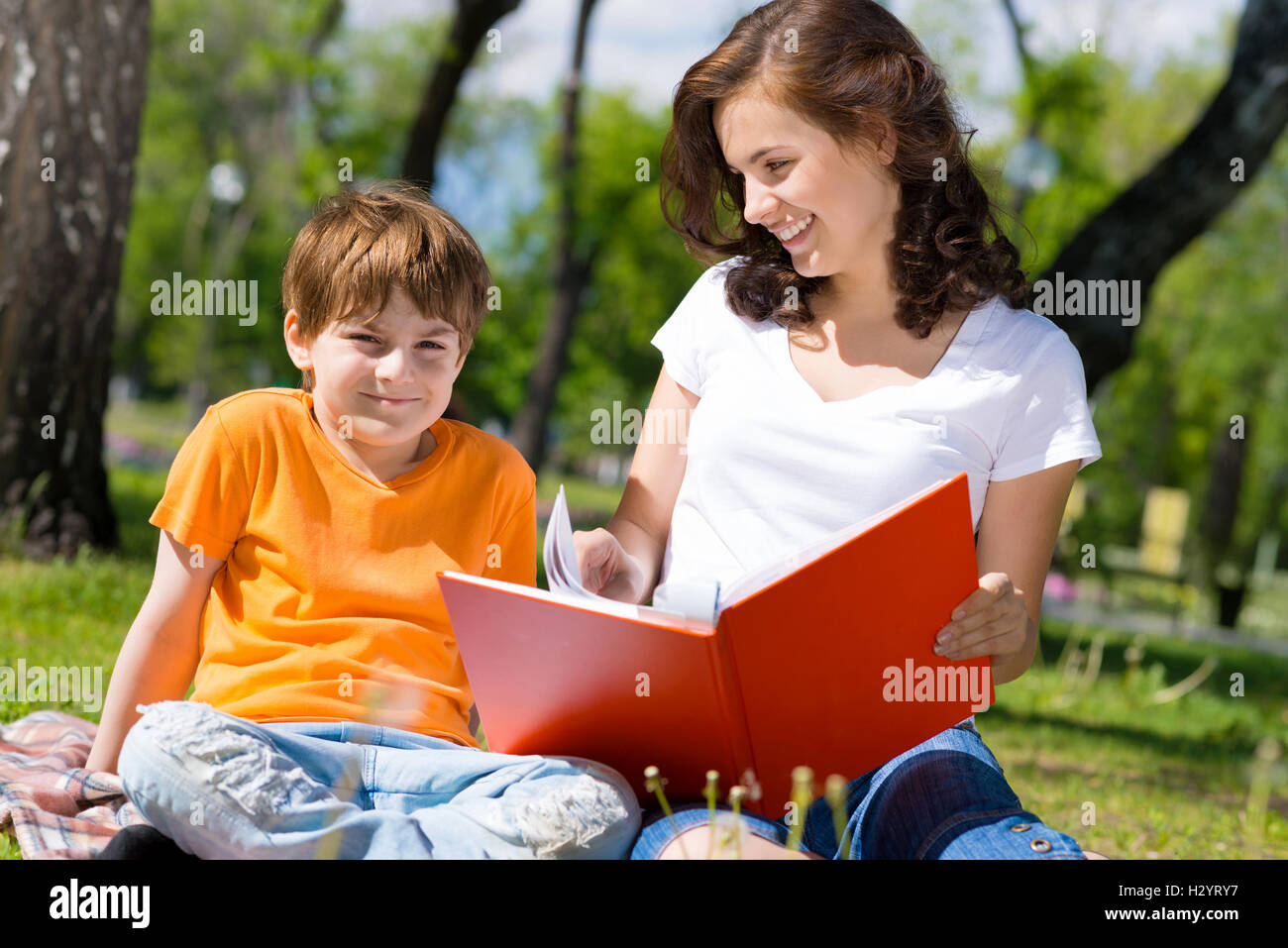 reading a book together Stock Photo - Alamy