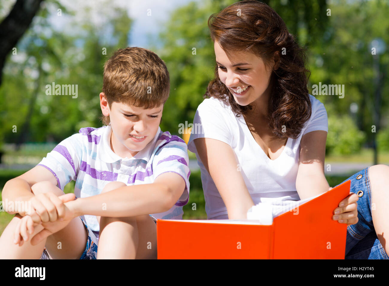 reading a book together Stock Photo - Alamy