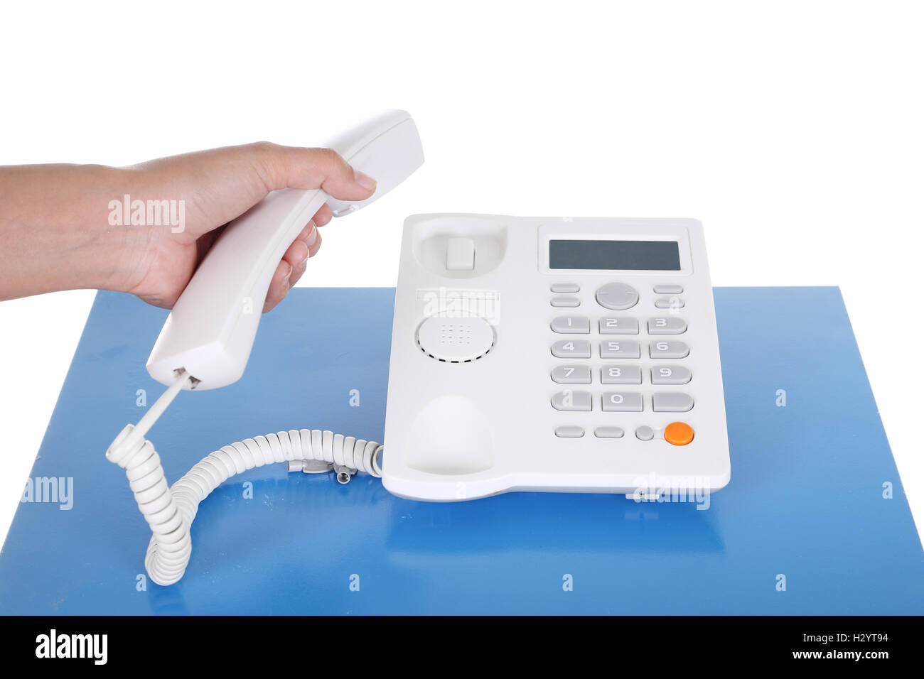 hand with telephone on a table Stock Photo - Alamy