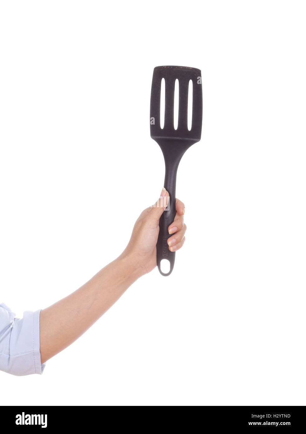 woman hand holding a kitchen spatula Stock Photo - Alamy