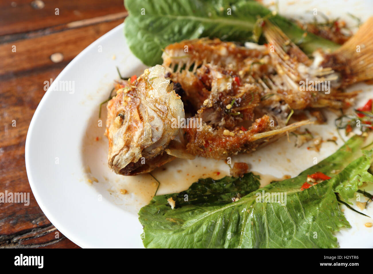 eaten Fried ruby fish topped with sweet,sauer and hot sauce Stock Photo ...