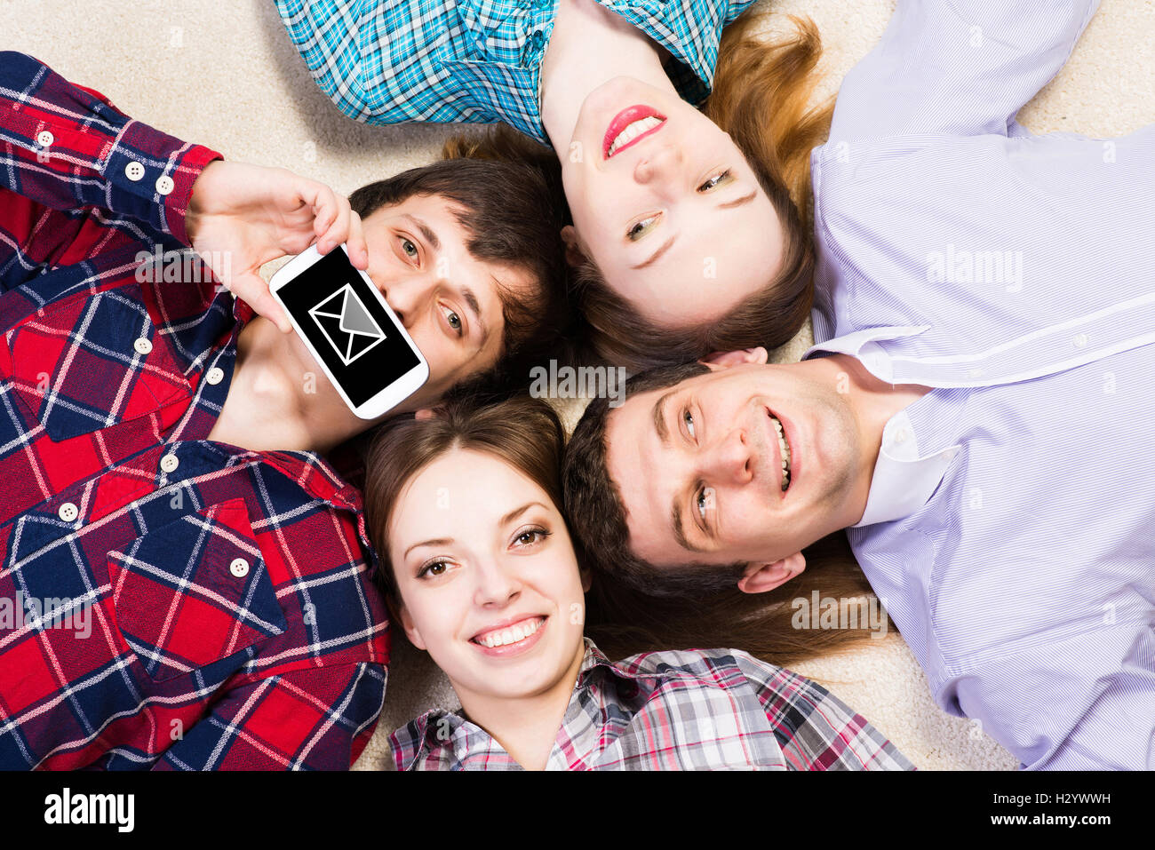 four young men lie together Stock Photo - Alamy