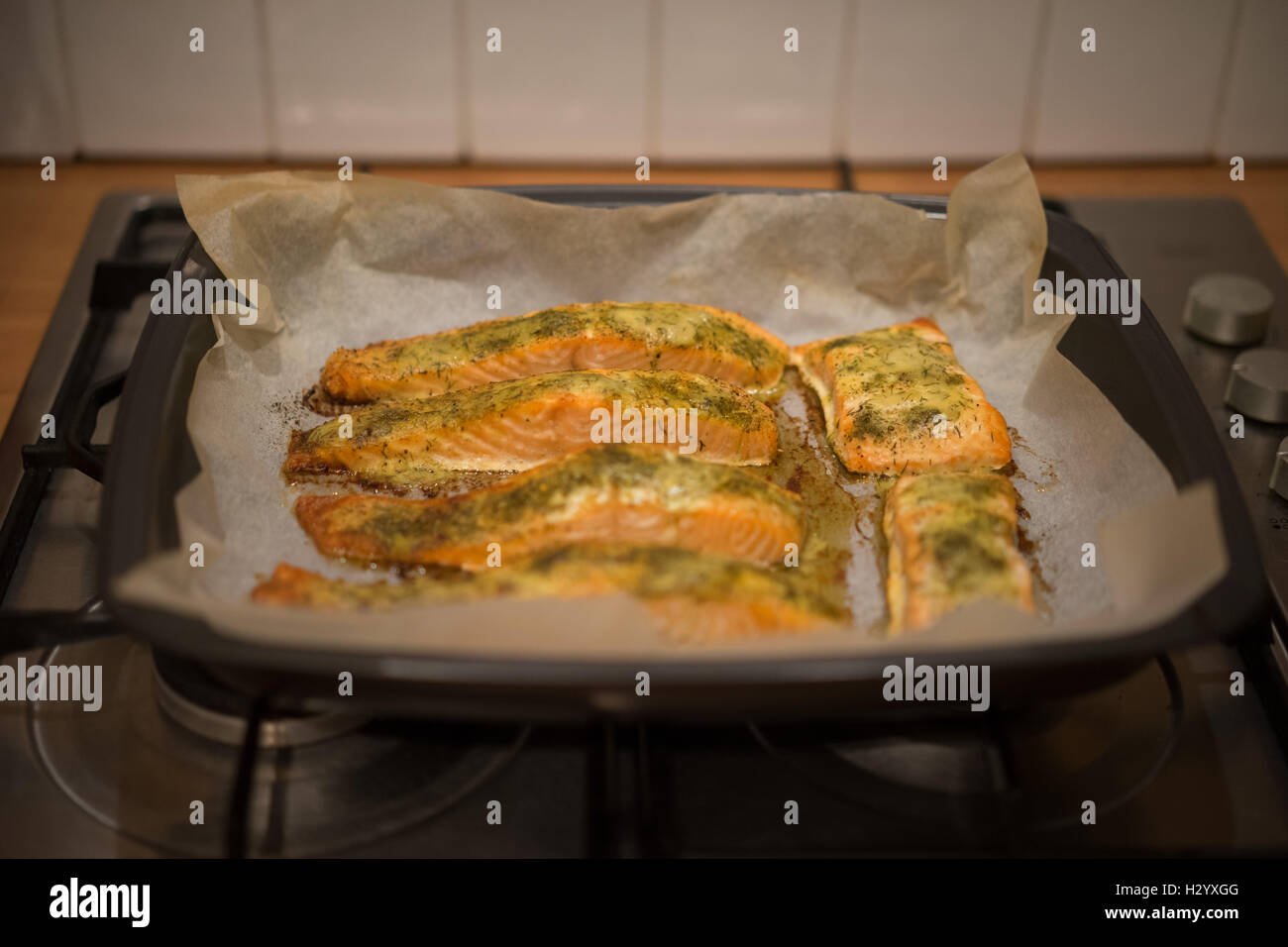 Preparing baked fish in a roasting pan Stock Photo - Alamy