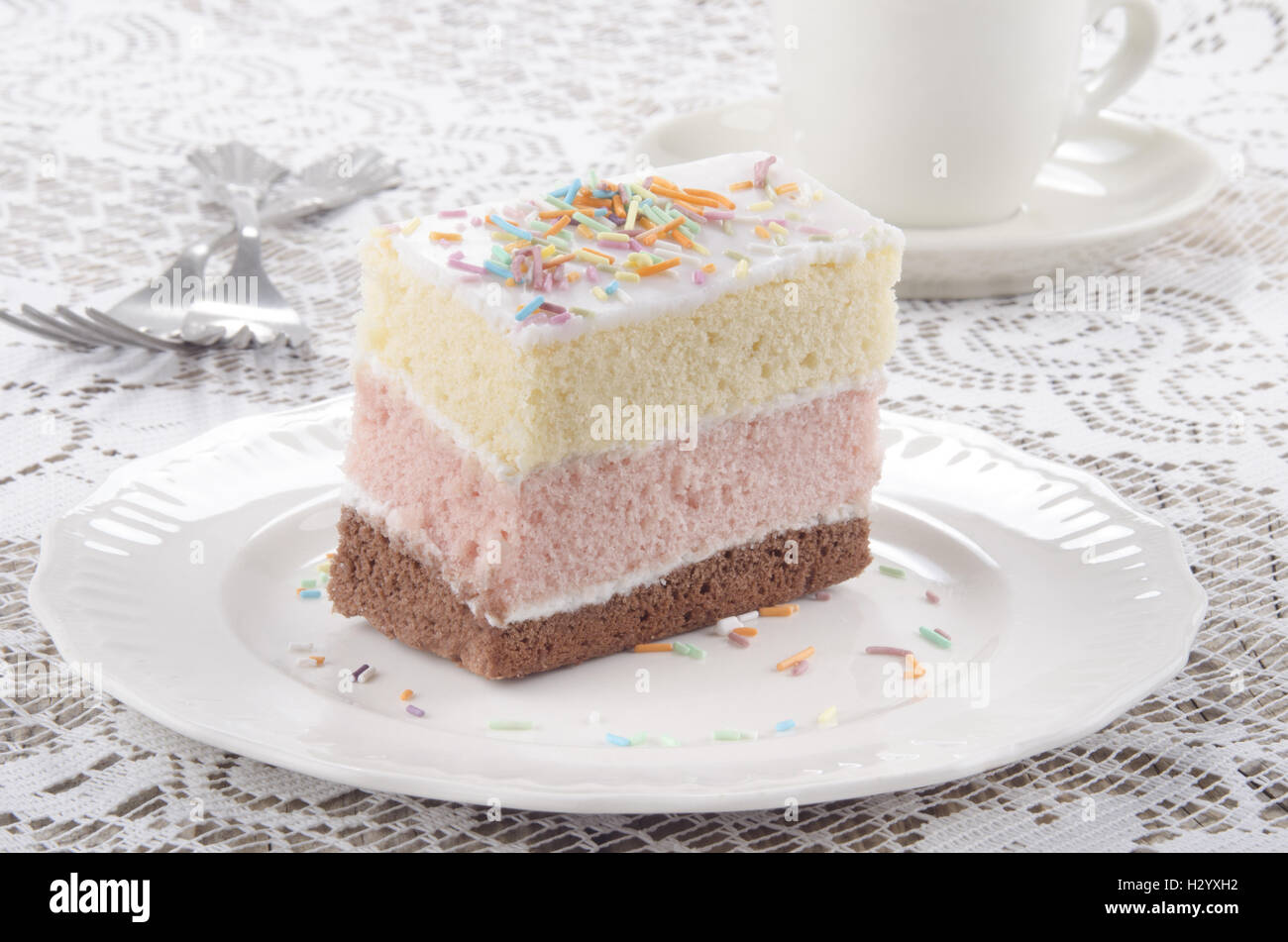 three layer cake with coloured sprinkle Stock Photo - Alamy