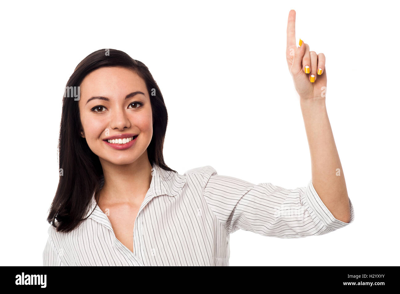 Smiling girl pointing upwards Stock Photo - Alamy