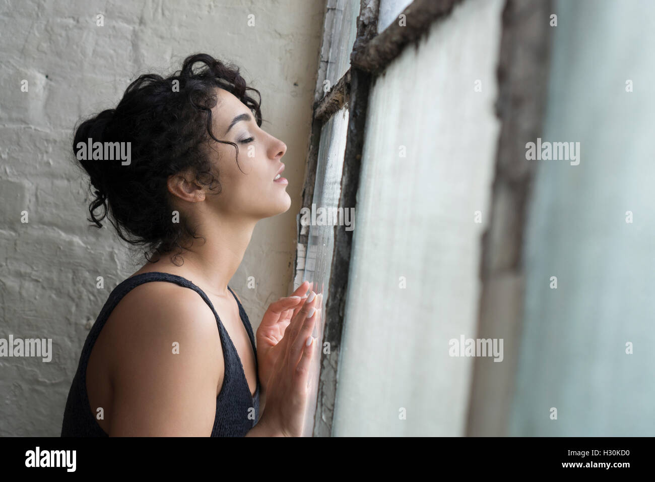 Woman Leaning Against Glass Window High Resolution Stock Photography ...