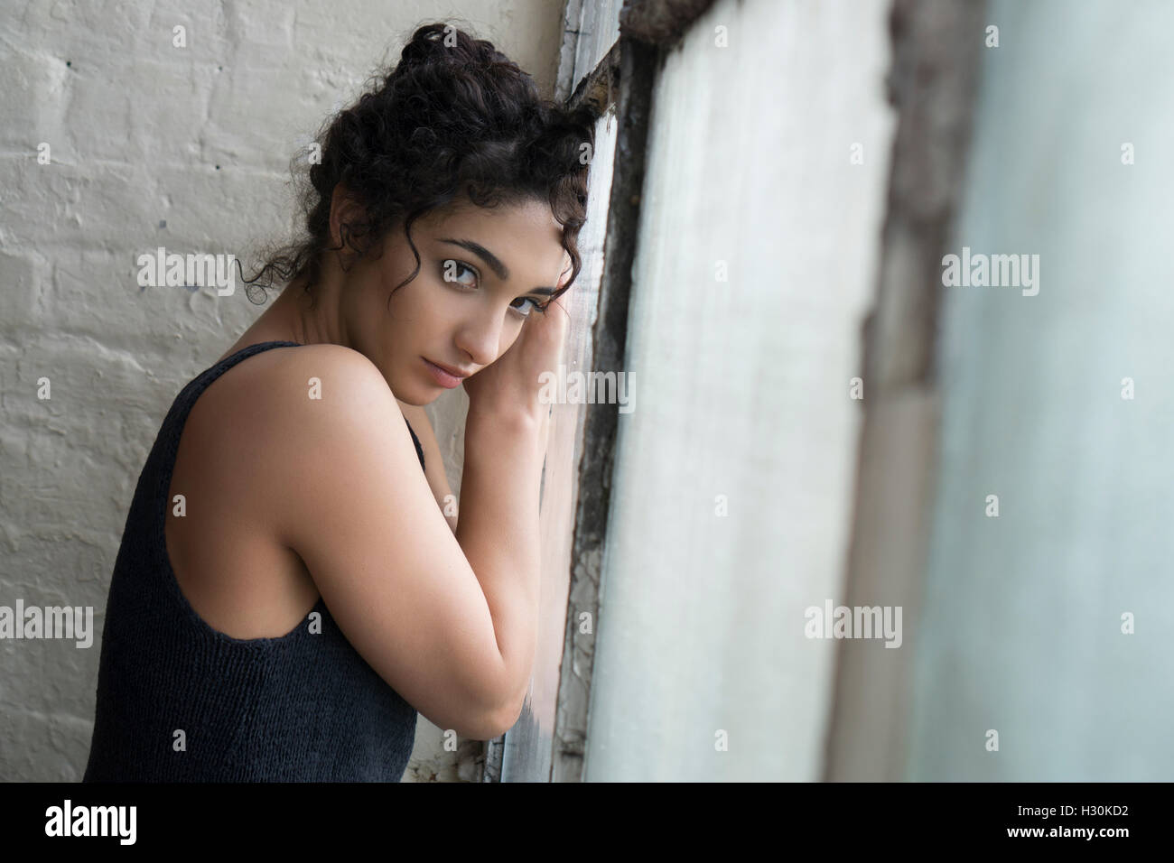 Woman leaning against glass window hi-res stock photography and images ...