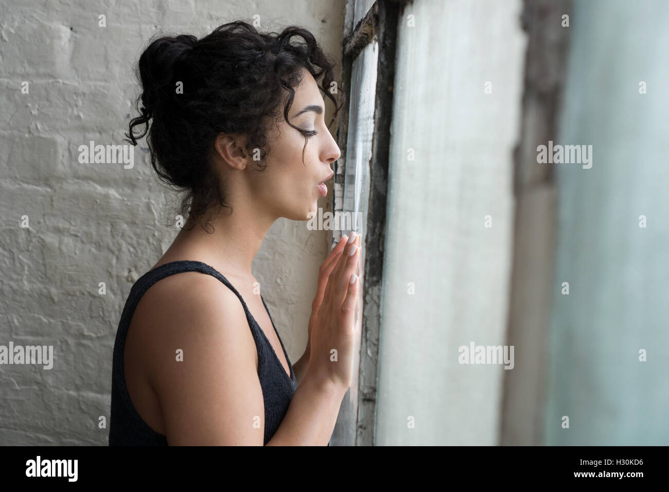 Young woman fogging the glass Stock Photo - Alamy