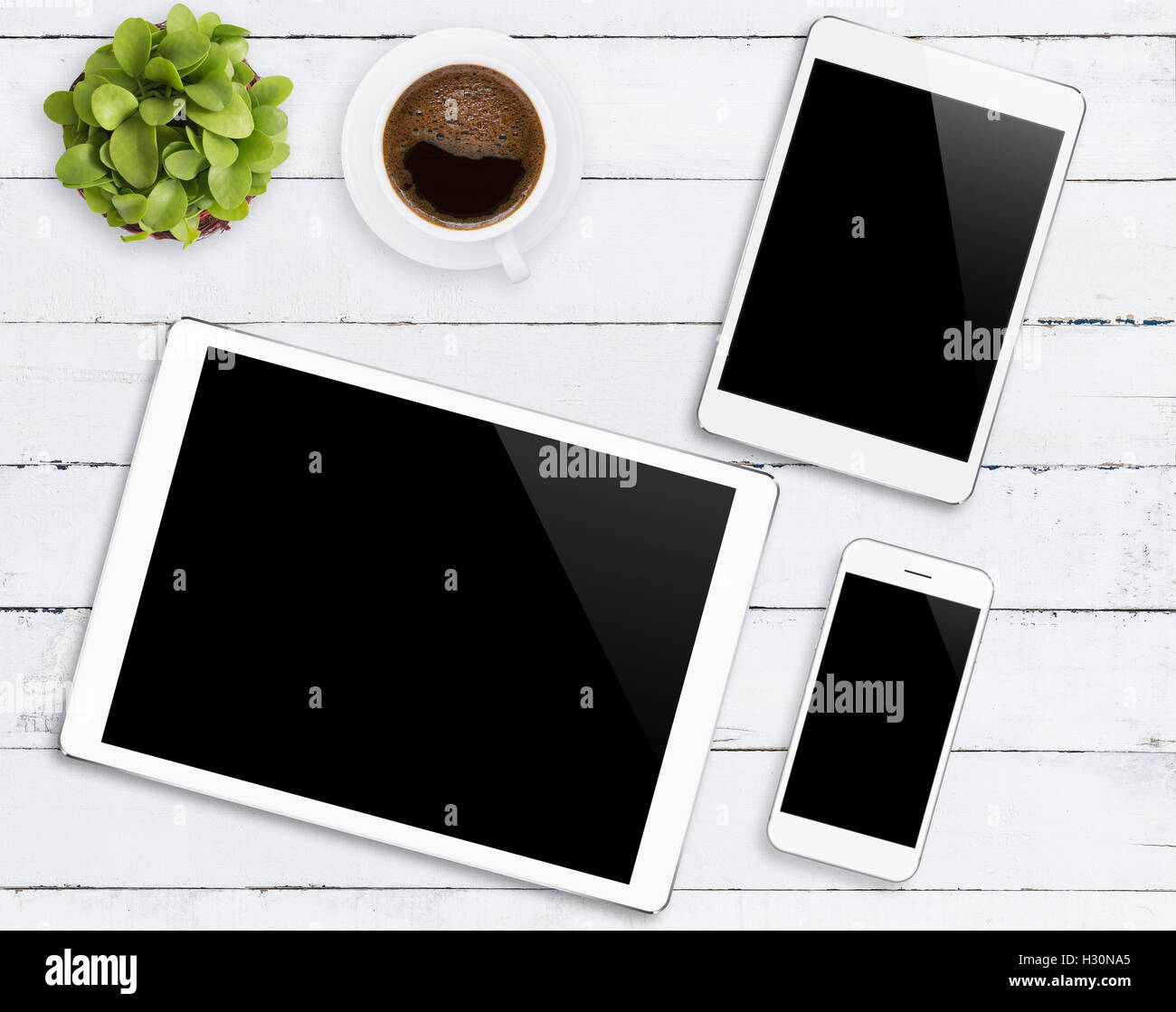 communicator device phone and tablet white color tone on wood table ...