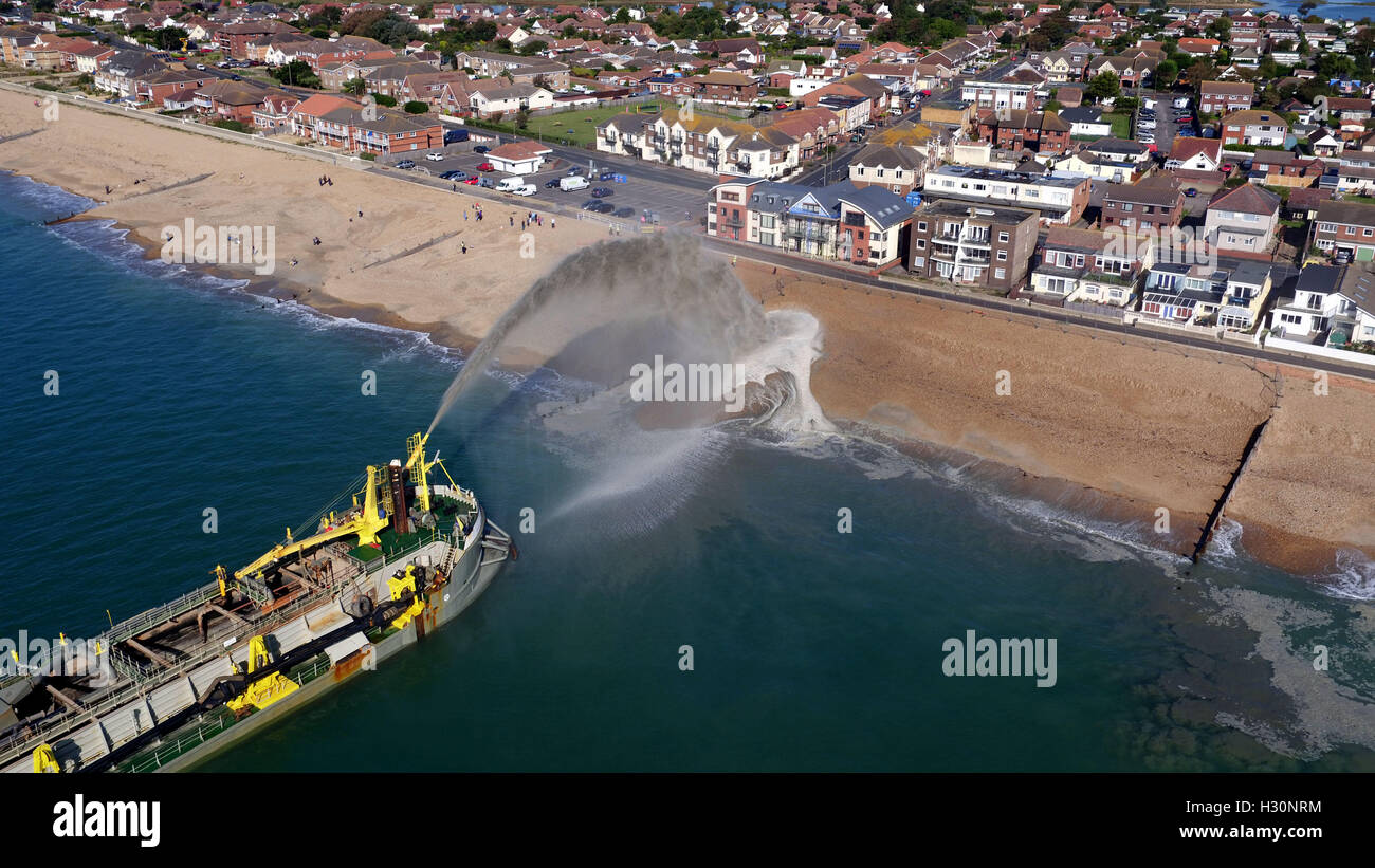 An aerial view of a dredger pumping shingle on to Eastoke beach at ...