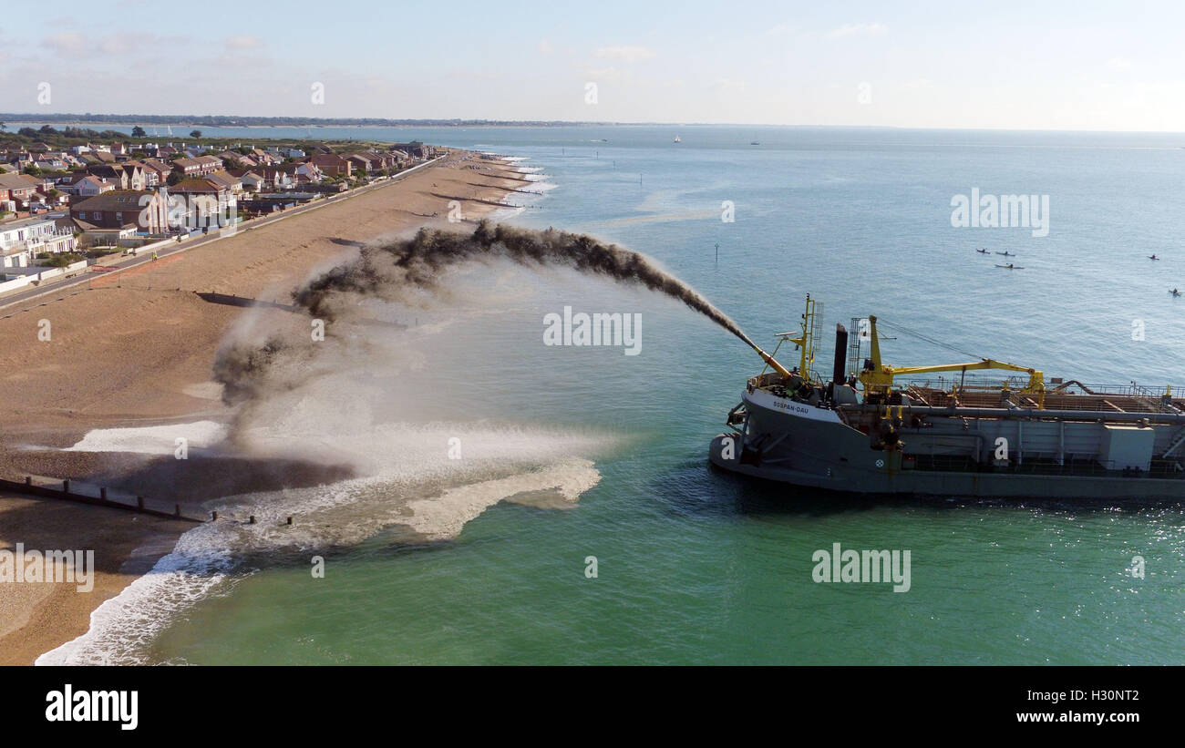 An aerial view of a dredger pumping shingle on to Eastoke beach at ...
