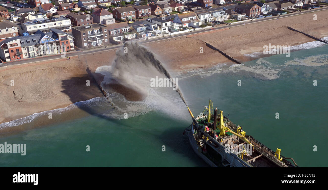 An aerial view of a dredger pumping shingle on to Eastoke beach at ...