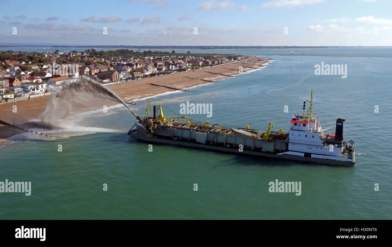 An aerial view of a dredger pumping shingle on to Eastoke beach at ...