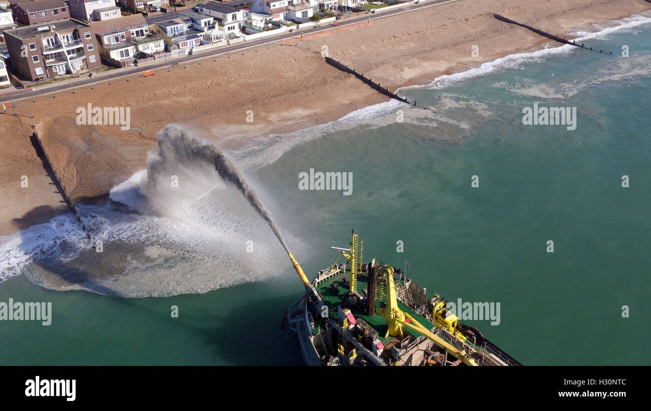 An aerial view of a dredger pumping shingle on to Eastoke beach at ...