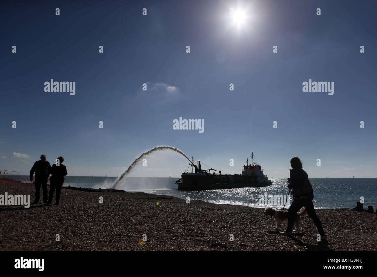 A dredger pumps shingle on to Eastoke beach at Hayling Island in ...