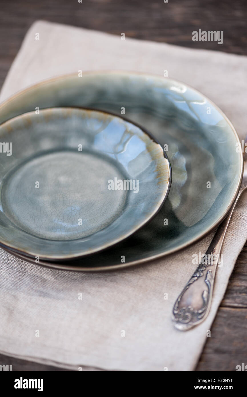 Two gray plates on a table Stock Photo - Alamy