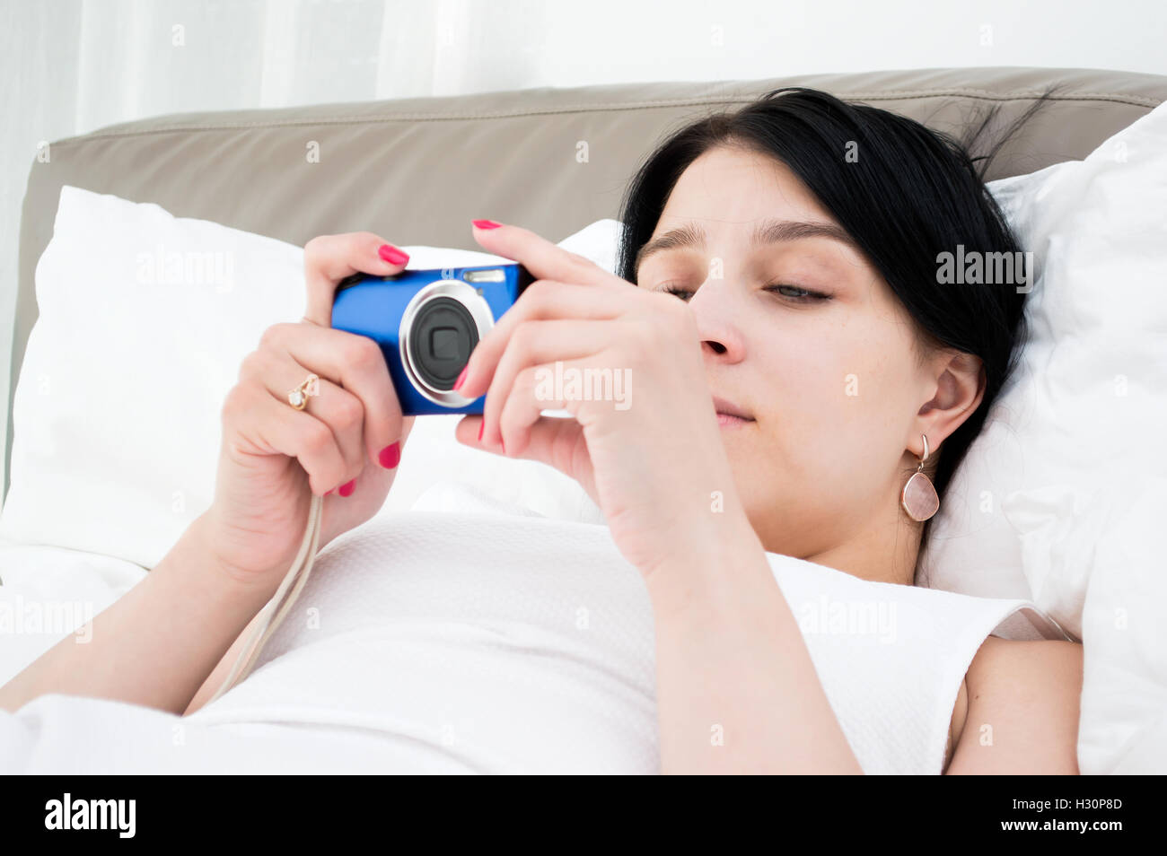Watching photos made by modern small digital camera Stock Photo - Alamy