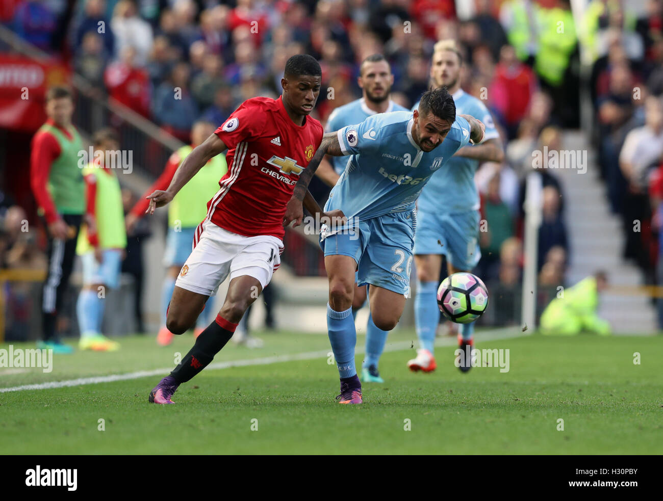 Manchester United's Marcus Rashford (left) and Stoke City's Geoff ...