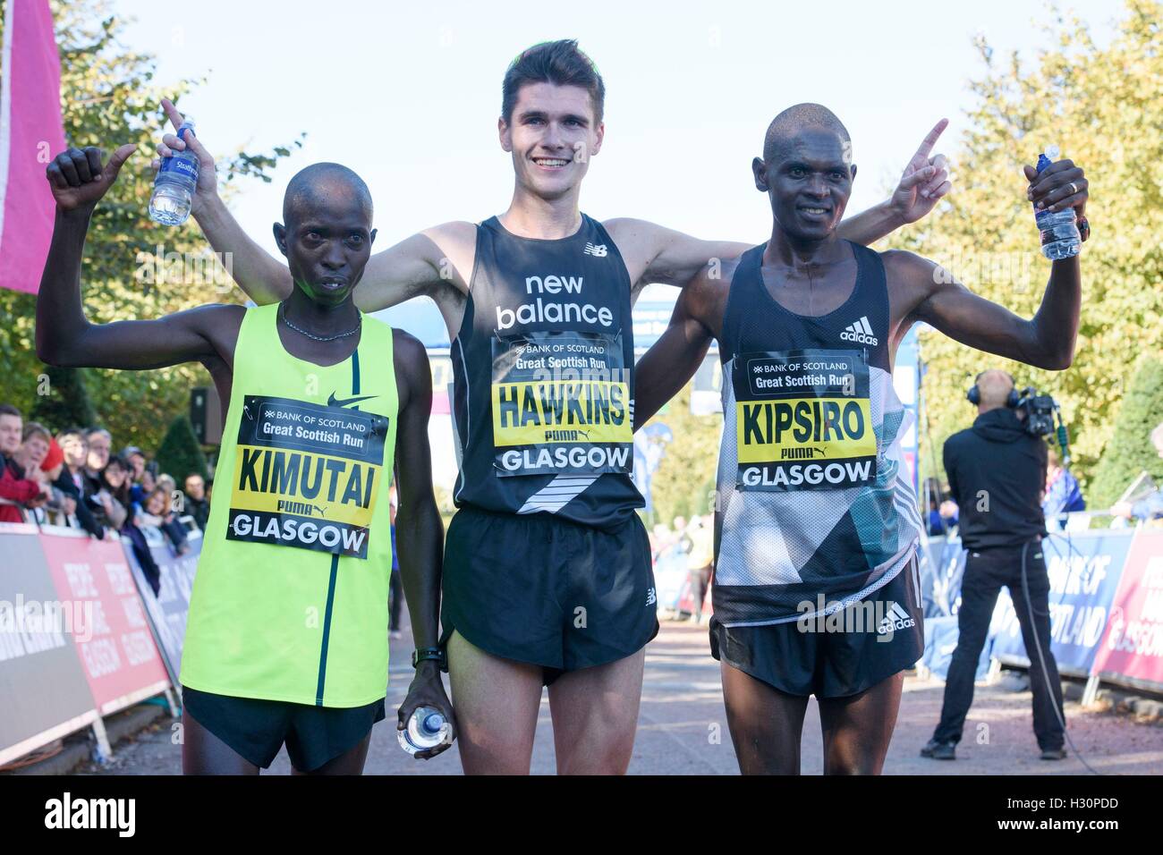 Scottish runner Callum Hawkins (centre) celebrates his victory in the ...
